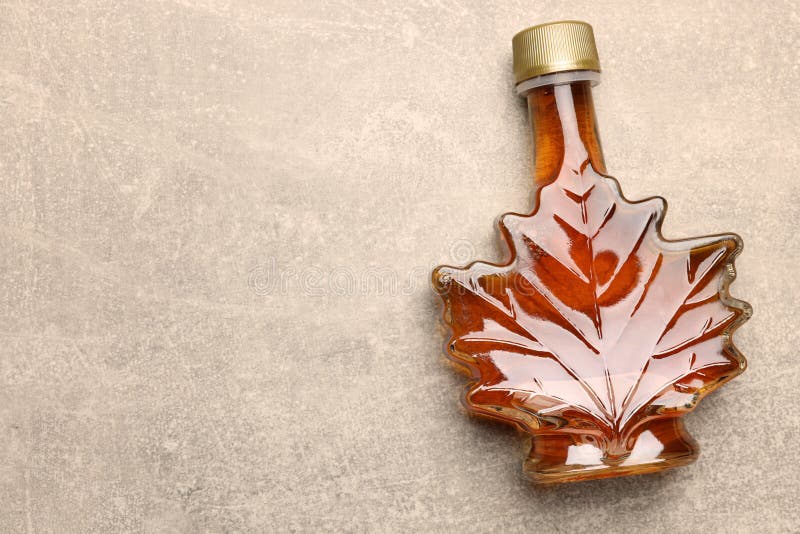 Leaf Shaped Bottle of Tasty Maple Syrup on Light Grey Table, Top View ...