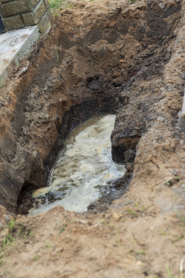 Leak from a Broken Water Pipe in a Trench Near a Construction Site ...