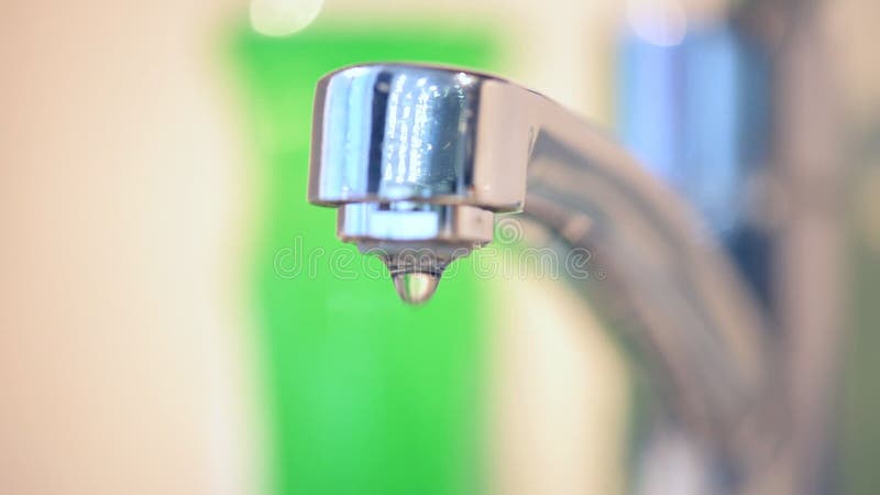 An Old Leaky Water Tower. Water Flows from a Large Iron Barrel Stock ...