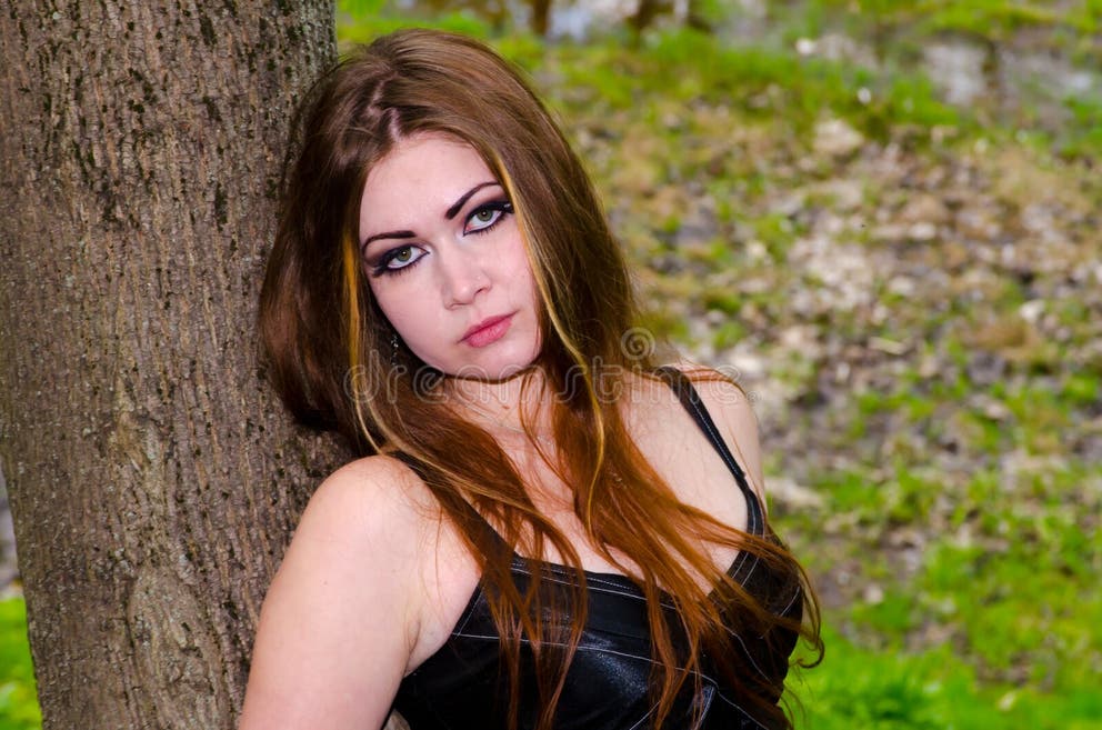 She is Leaning Back Against the Tree Stock Photo - Image of cute, adult ...