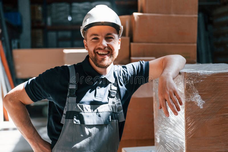 Leaning on the Box and Smiling. Employee in Uniform is Working in the ...