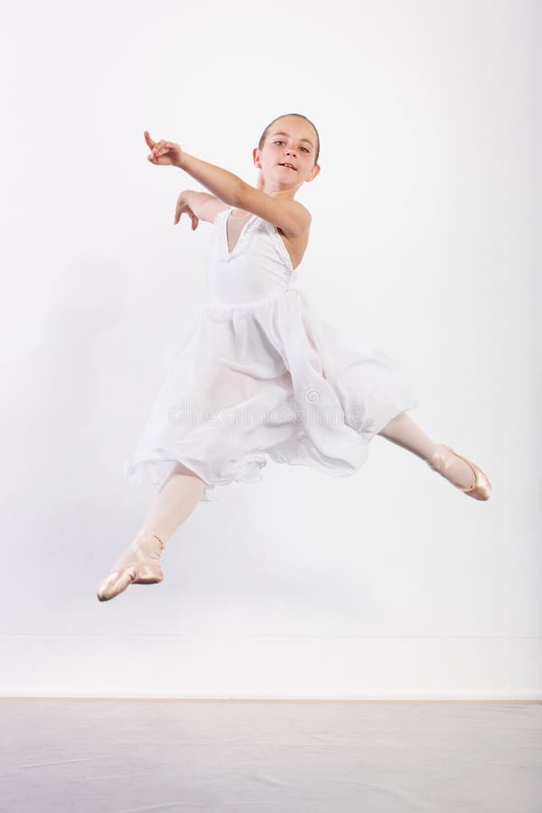 Leaping Gracefully. a Young Ballerina Leaping Across the Floor of a ...