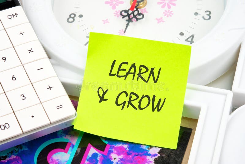 Learn and Grow Written on a Yellow Sticker Near the Calculator and the ...