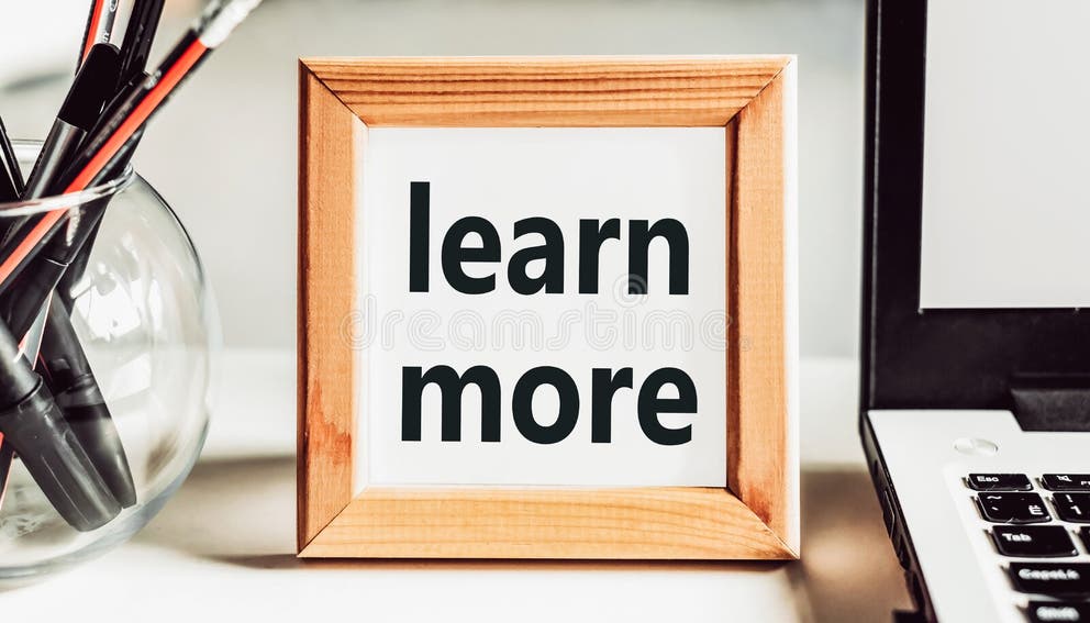 LEARN MORE Text in Wooden Frame on Office Table Stock Photo - Image of ...