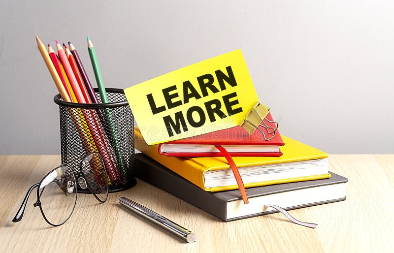 LEARN MORE Written on a Sticky on Notebooks Stock Image - Image of ...
