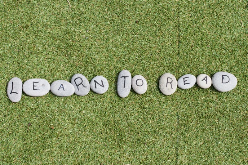 Learn To Read Spelt in Pebbles on Artificial Grass Stock Photo - Image ...