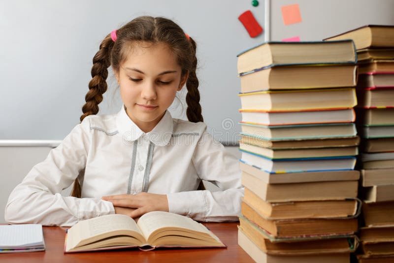 Learner Sitting Near the Stack of Books in the Classroom Stock Image ...
