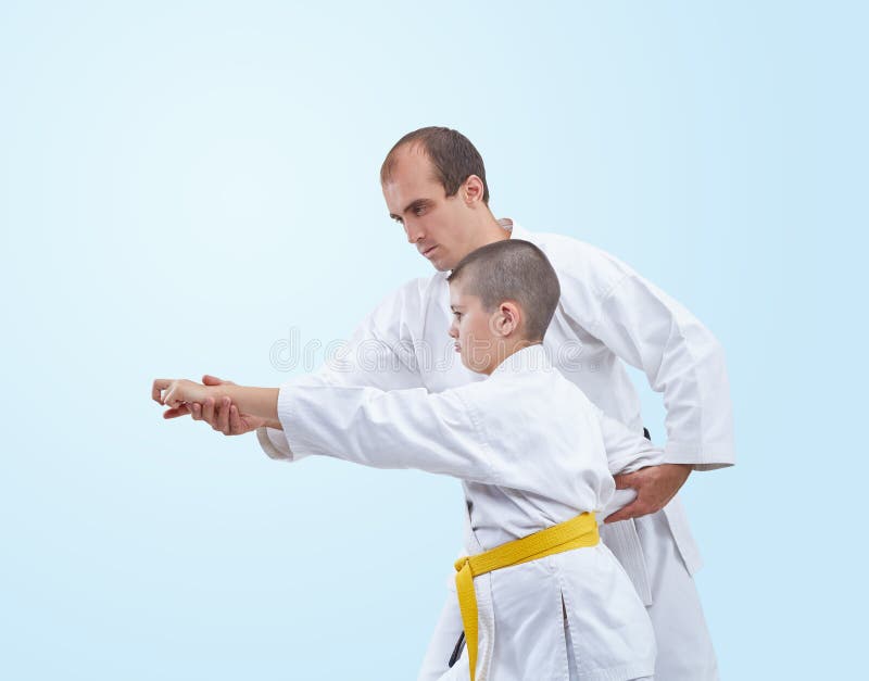 The Learner with a Yellow Belt Karate Coach Corrects Stock Photo ...