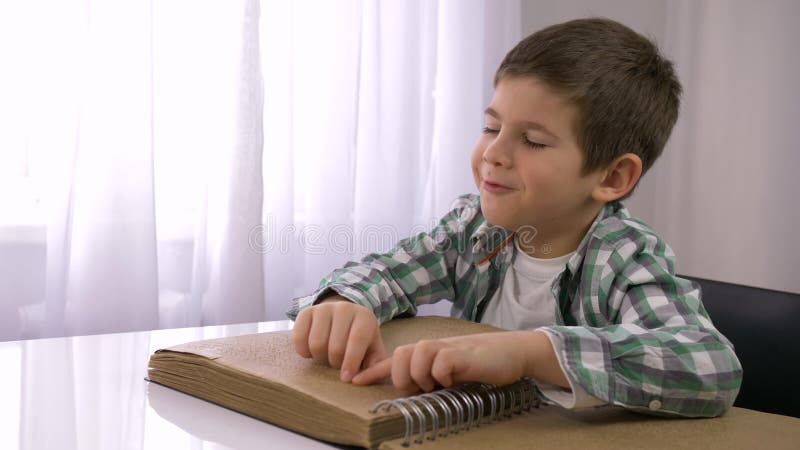 Blind Child Boy Reading Braille Book with Symbols Font for Visually ...