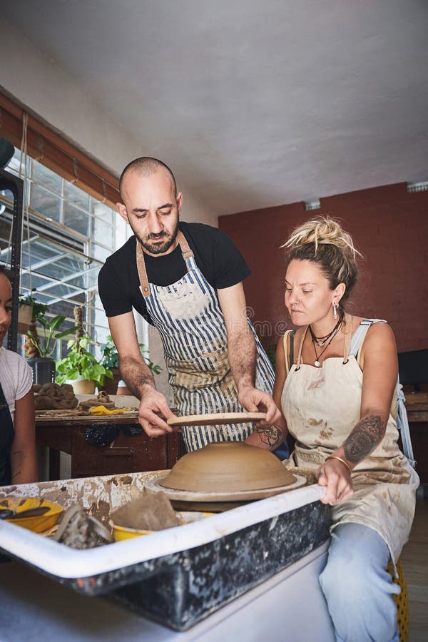 Learning from the Clay Guru Himself. a Group of Young People Working ...