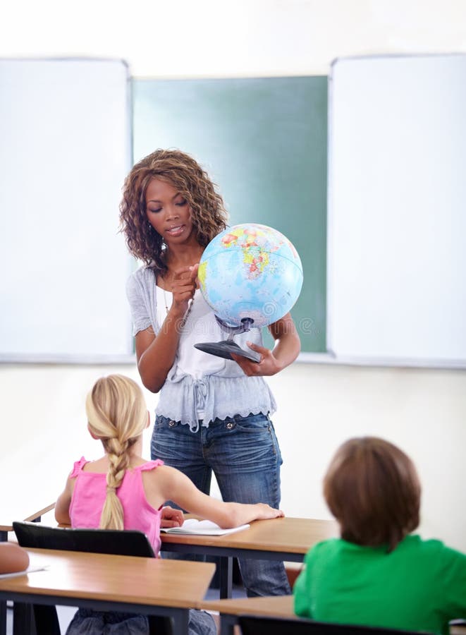 Learning about the Continents. a Young Teacher Showing Her Class a ...