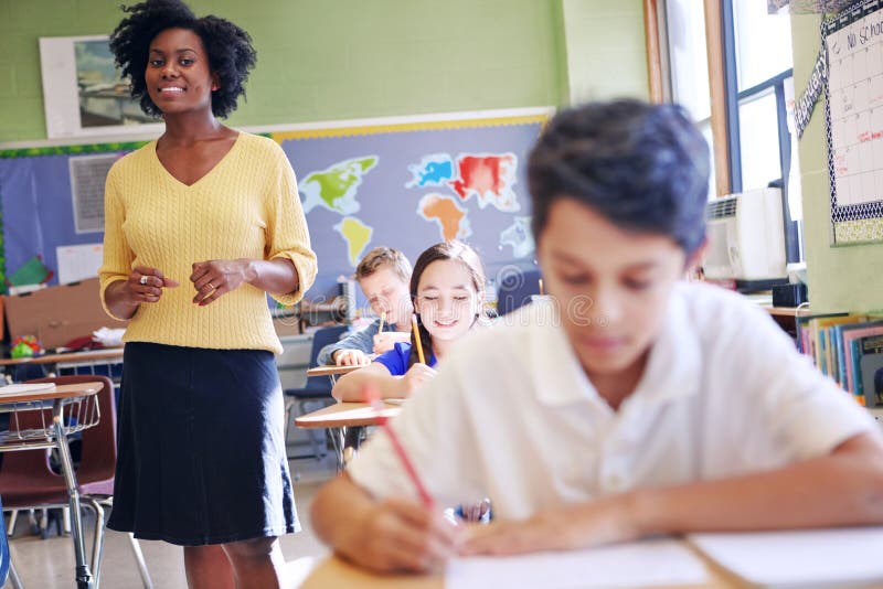 Learning, Education and Portrait of Teacher with Students in Elementary ...
