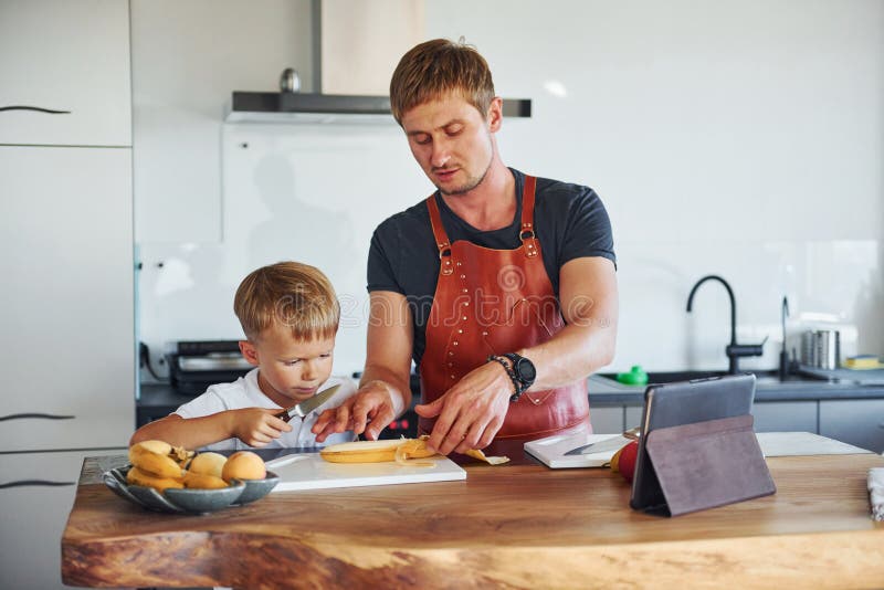 Learning How To Cook. Father and Son is Indoors at Home Together Stock ...