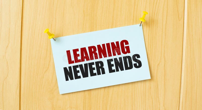 LEARNING NEVER ENDS Sign Written on Sticky Note Pinned on Wooden Wall ...