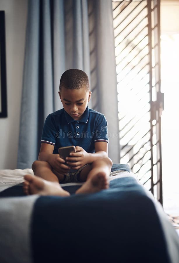 Learning New Words Online. a Young Boy Using a Cellphone while Sitting ...