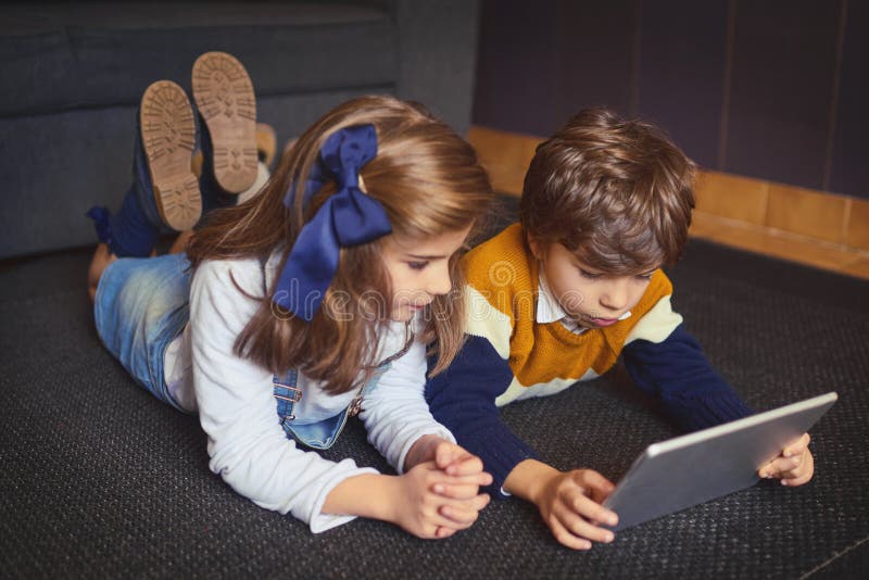 Learning Something New Everyday with Technology. a Little Boy and Girl ...