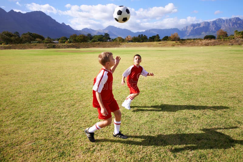 Learning Teamwork while Playing Together. Two Boys Playing Soccer on a ...