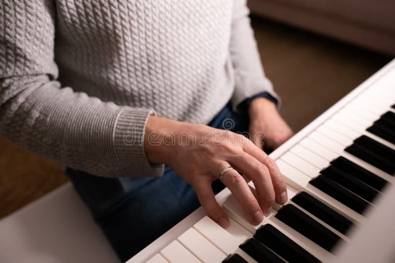 Learning To Play the Piano. a Man Plays an Instrument Stock Image ...