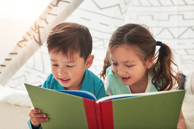 Learning To Read Together. Two Adorable Young Siblings Reading a Book ...
