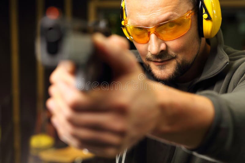 Learning to shoot a gun. stock image. Image of safety - 80071131