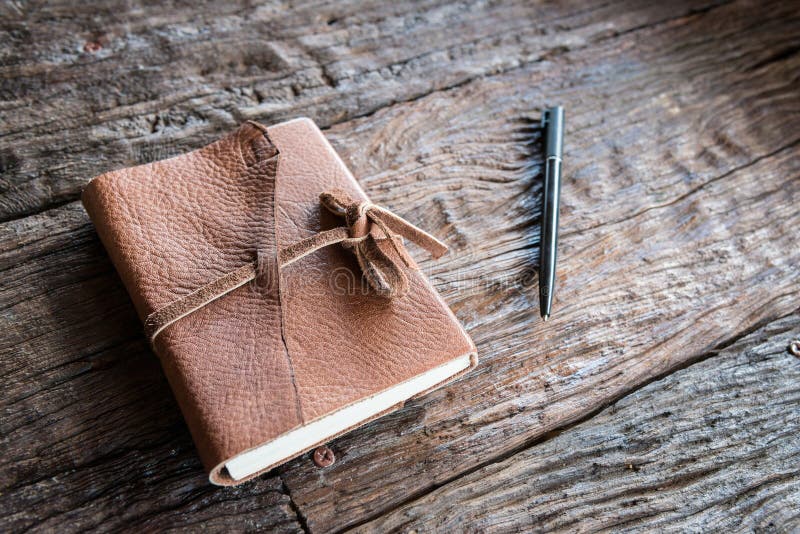 The Leather Book and Pen on the Wood Table. Stock Photo - Image of ...