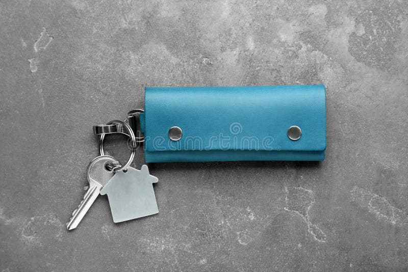 Leather Case with Key on Grey Textured Table, Top View Stock Photo ...