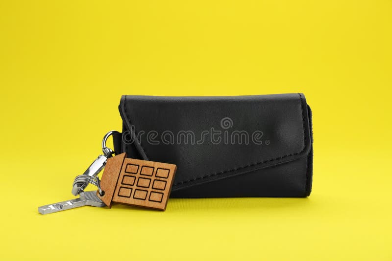 Leather Case with Key on Yellow Background Stock Photo - Image of ...
