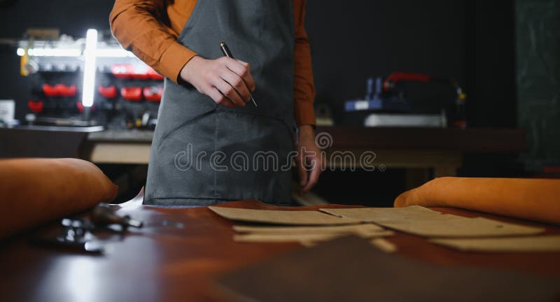 Leather Craftsman is Carefully To Make a Leather Product for a Customer ...
