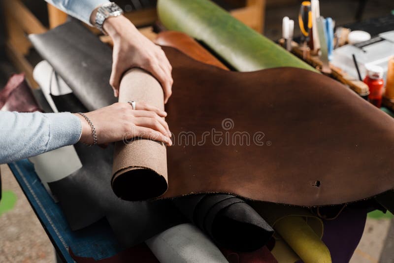 Leather Craftsman is Touching Roll of Genuine Leather in the Workshop ...