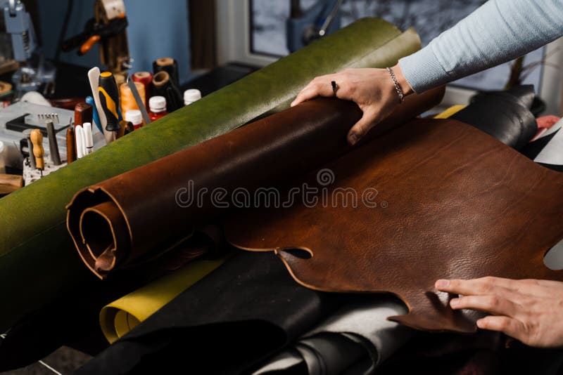 Leather Craftsman is Touching Roll of Genuine Leather in the Workshop ...