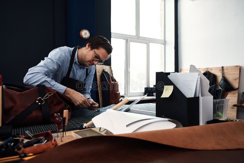 Leather Craftsmen Working Making Measupenets in Patterns at Table in ...