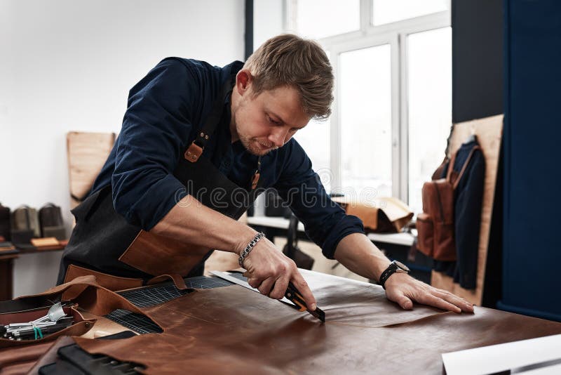 Leather Craftsmen Working Making Measupenets in Patterns at Table in ...