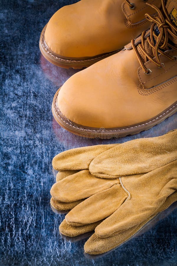 Leather Safety Working Boots and Gloves on Scratched Metallic Ba Stock ...