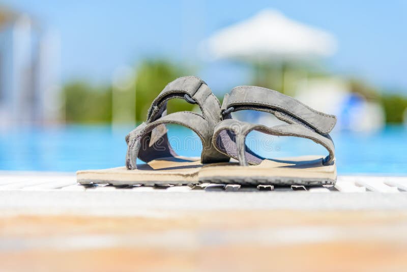 Leather Sandals are on the Edge of the Swimming Pool Stock Photo - Image of side, edge: 36378208