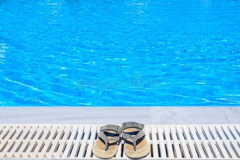 Leather Sandals are on the Edge of the Swimming Pool Stock Photo - Image of side, edge: 36378208