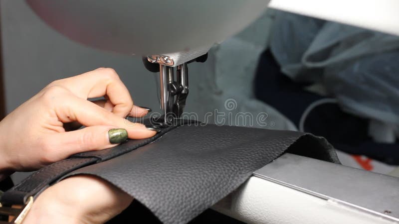 Leather Sewing Machine in Action in a Workshop with Hands Working on a ...
