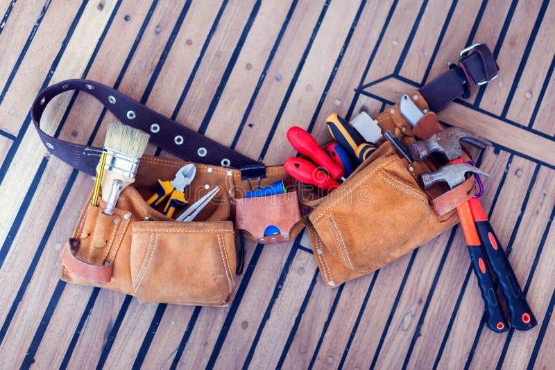 Leather Tool Belt with Construction Tooling on the Wooden Board ...
