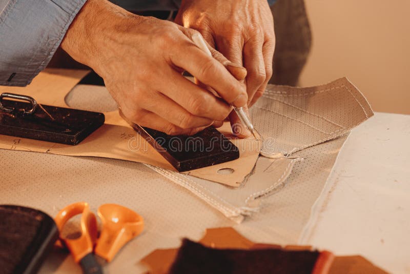 Leatherworker Making a Leather Clothing with White Fabric in a Studio ...