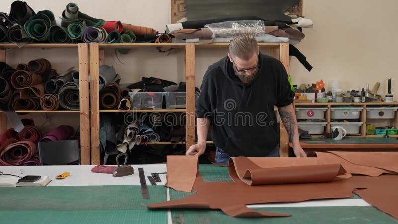 Leatherworker Measuring and Cutting Leather in Workshop. Stock Video ...