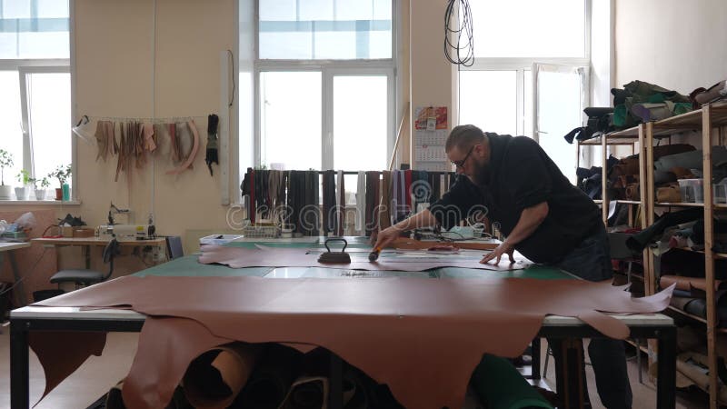 Leatherworker Measuring and Cutting Leather in Workshop. Stock Footage ...