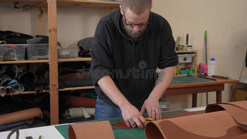 Leatherworker Measuring and Cutting Leather in Workshop. Stock Video ...