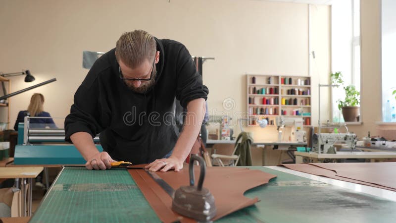 Leatherworker Measuring and Cutting Leather in Workshop. Stock Video ...