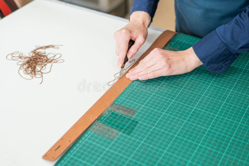 Leatherworker Measuring and Cutting Leather in Workshop. Stock Image ...