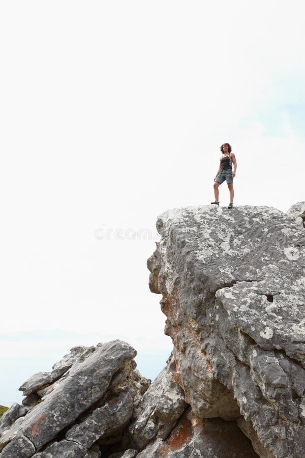 Leaving the World Behind. a Rock Climber Standing on the Top of a Cliff ...