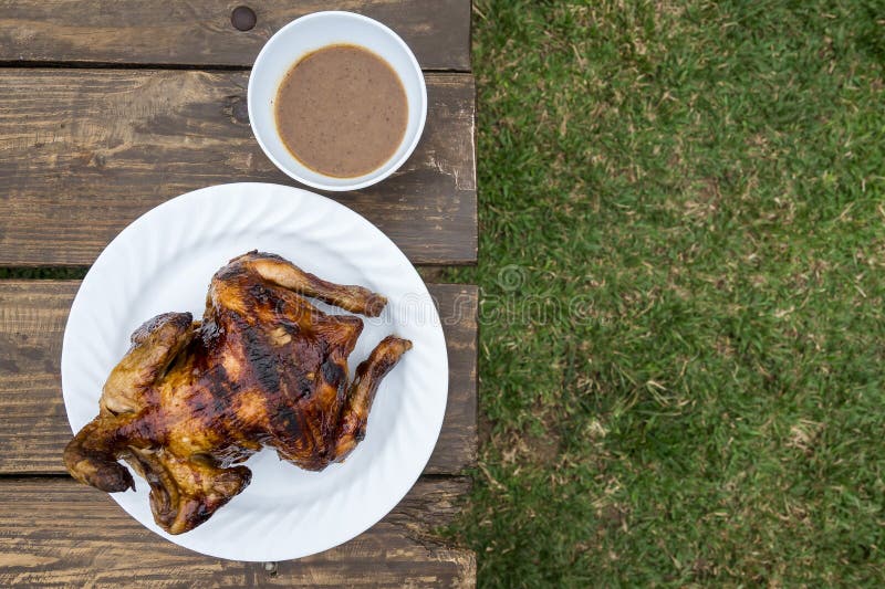 Lechon Manok, or Roasted Chicken Served Outside at a Bench with Gravy ...