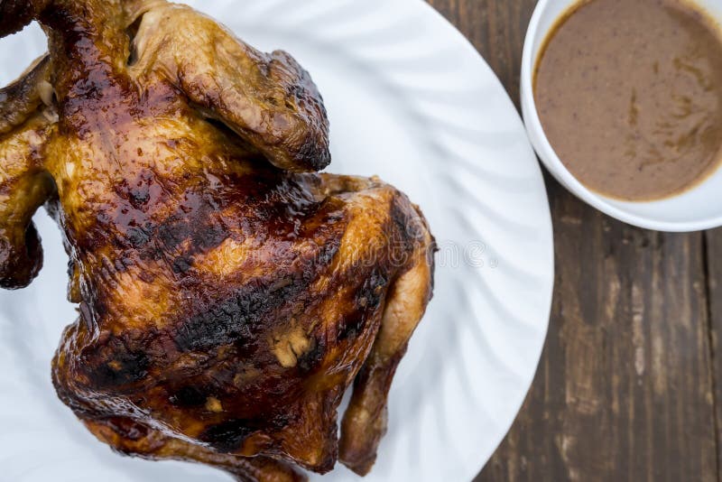 Lechon Manok, or Roasted Chicken Served Outside at a Bench with Gravy ...