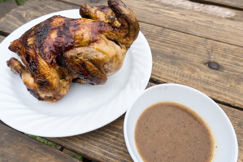 Lechon Manok, or Roasted Chicken Served Outside at a Bench with Gravy ...