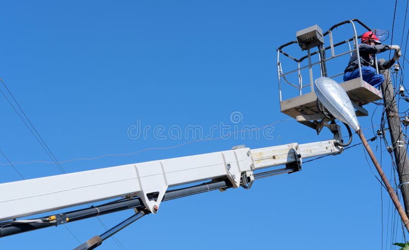 Lectrician Man Serves Electrical Lines and Pole at Height Using ...