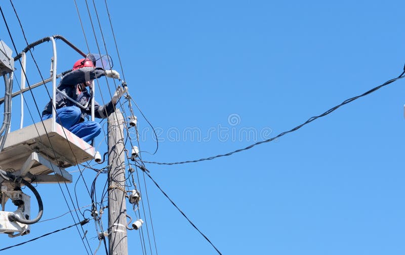 Lectrician Man Serves Electrical Lines and Pole at Height Using ...
