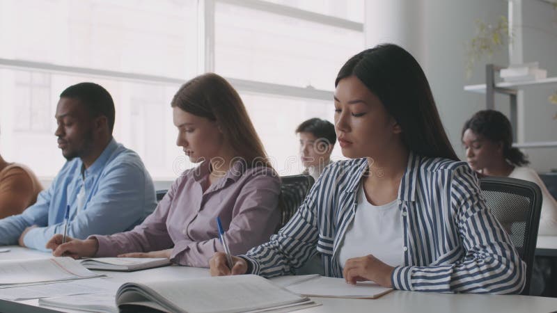 Lecture at College. Group of International Students Writing Notes ...